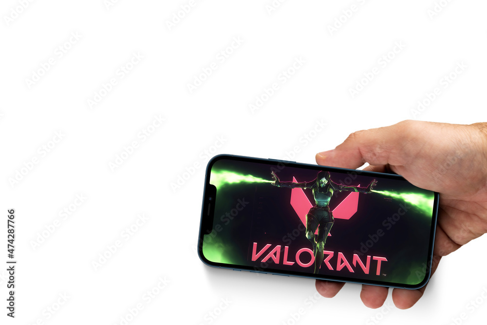 Male hand holding a smartphone with Valorant mobile game app on the ...