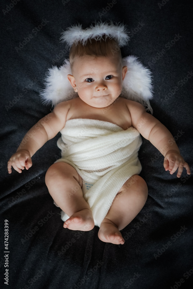 cute happy innocent newborn baby in white angel outfit with feather ...