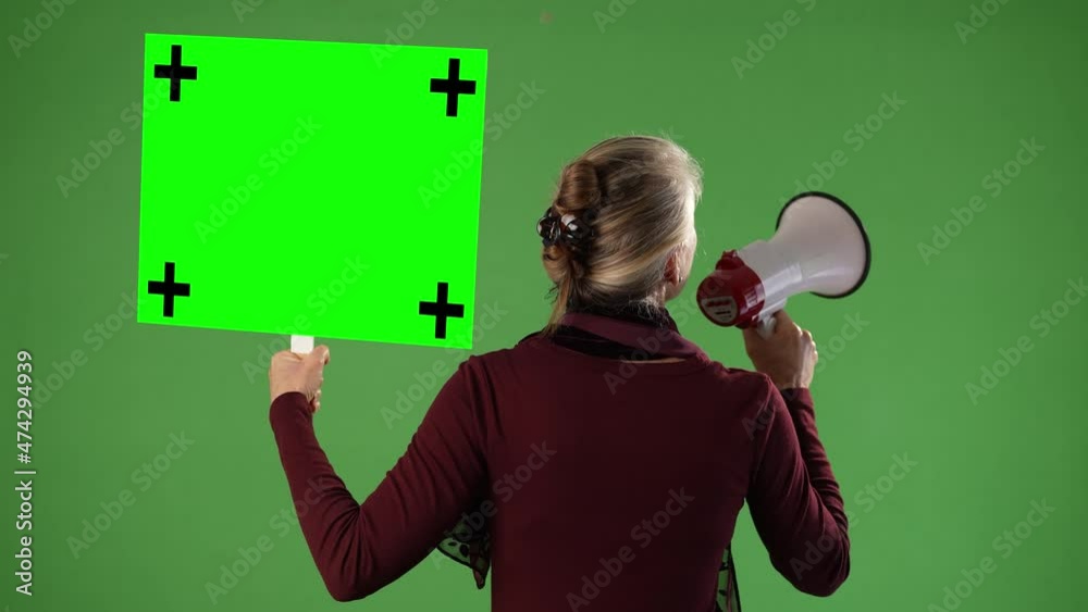 Woman facing away from camera holding green screen chroma key blank ...