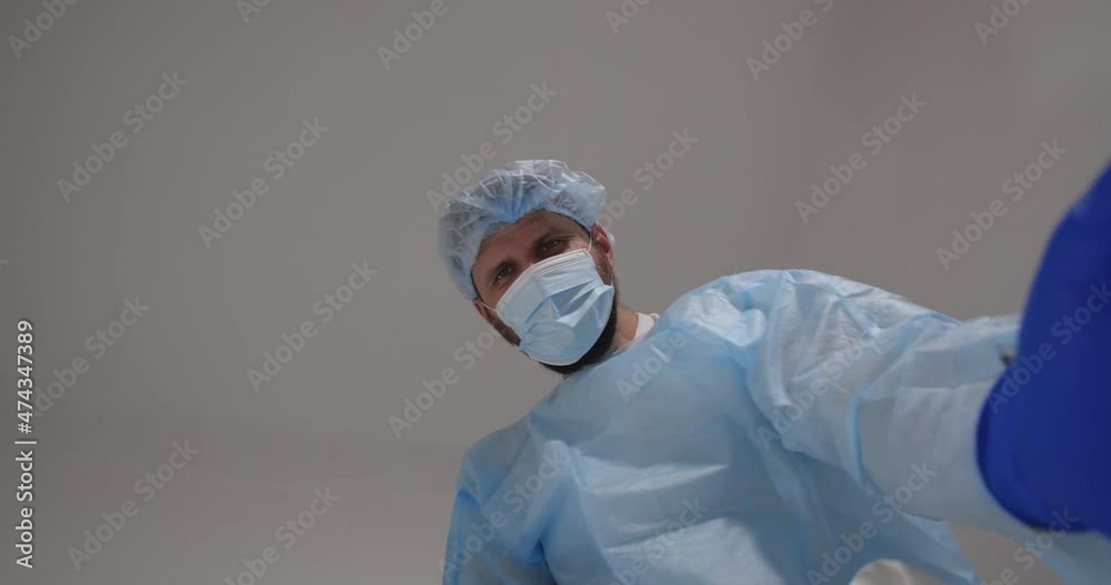 Low angle shot point of view, doctor and nurse bent over the dead body ...