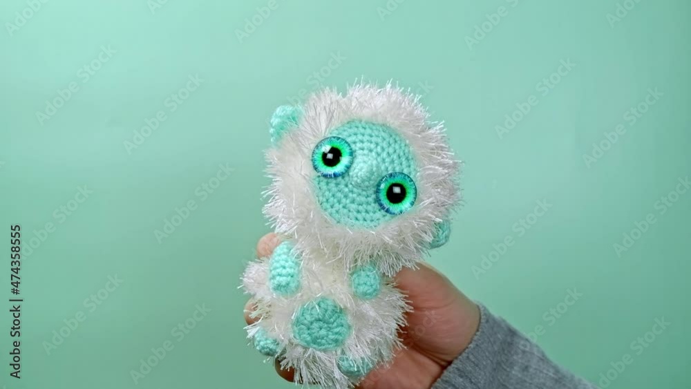 Dancing Yeti Bigfoot in hands. Handmade crocheted soft toy. Surf green ...
