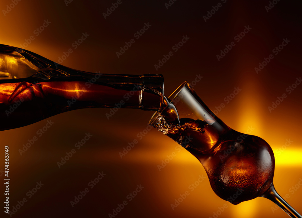 Pouring an alcoholic drink. Stock Photo | Adobe Stock