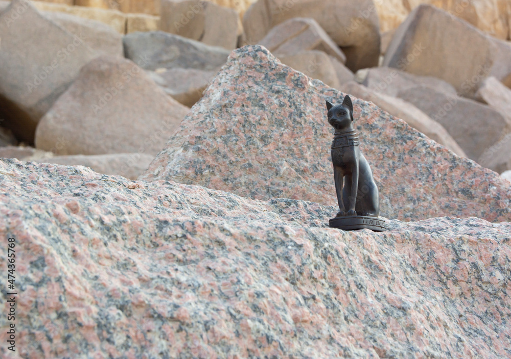 Egyptian statue of a cat made of basalt against the background of the ...