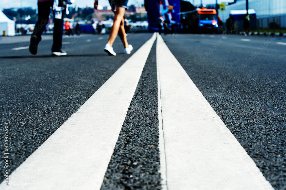 Road markings are double continuous lane on an asphalt road. Feet of ...