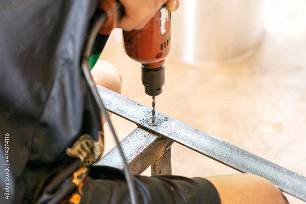 Construction workers use electric drills to drill steel. Stock Photo ...