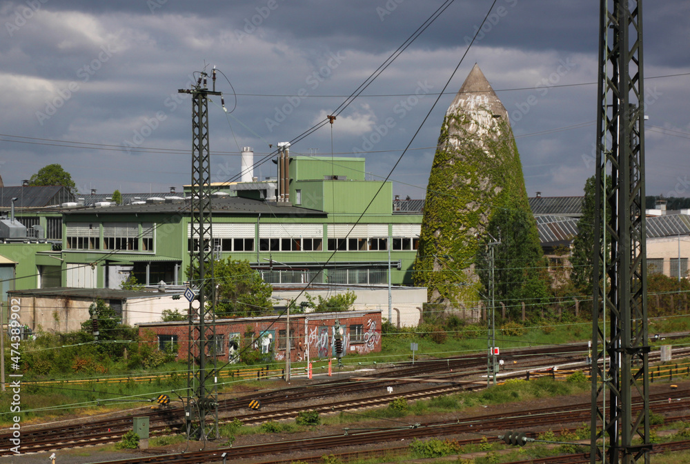Railroad tracks and industrial area with a conical concrete air raid ...