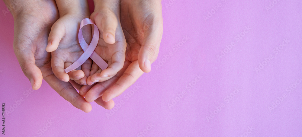 Adult and child hands holding pink ribbons, Breast cancer awareness ...
