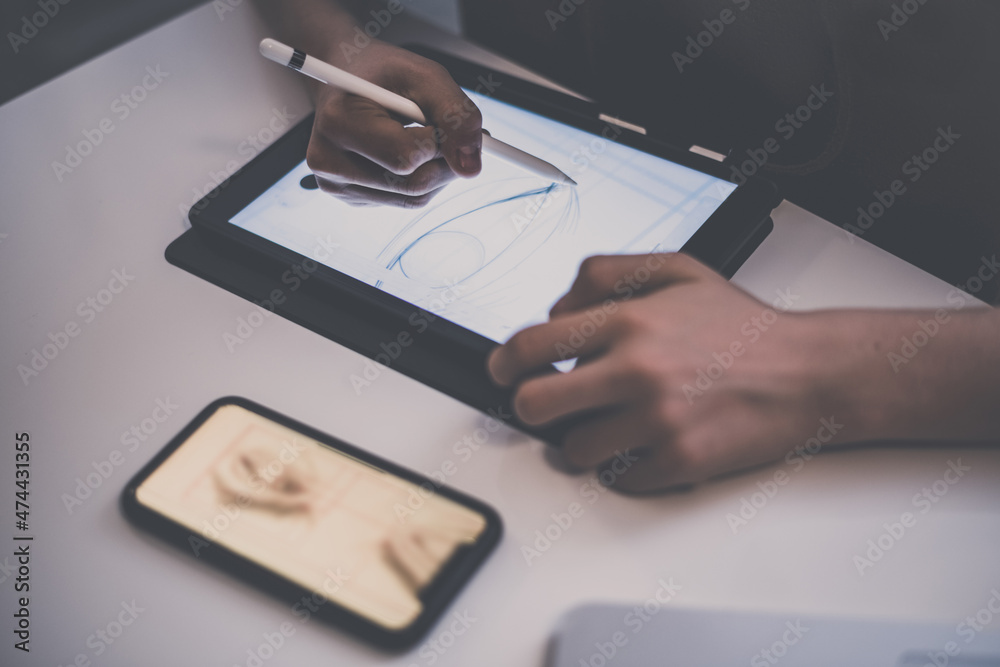 Teenager drawing with tablet and virtual pen. Millennial student doing ...