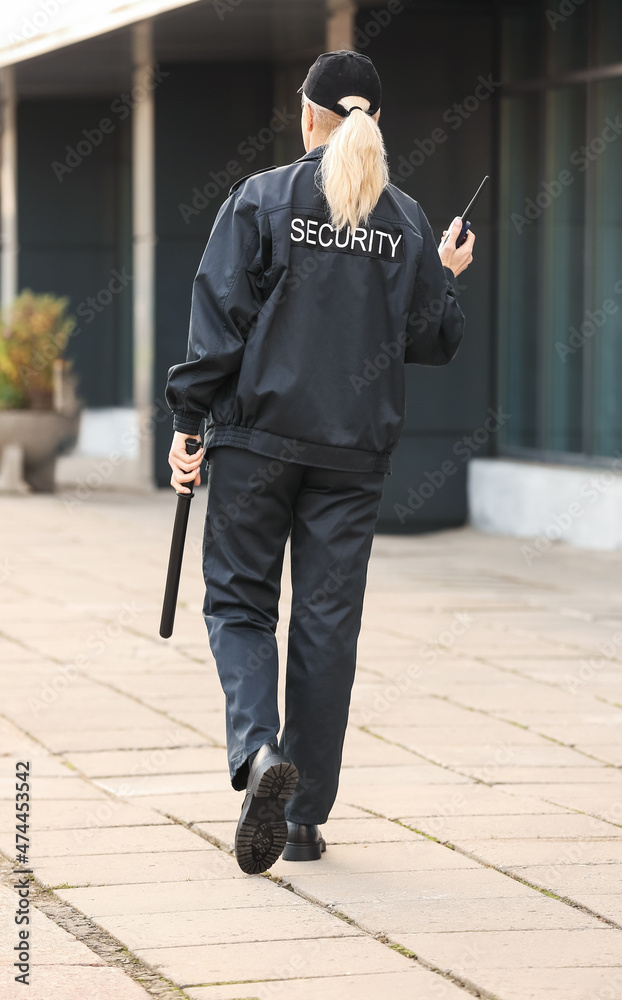 Female security guard outdoors, back view Stock Photo | Adobe Stock
