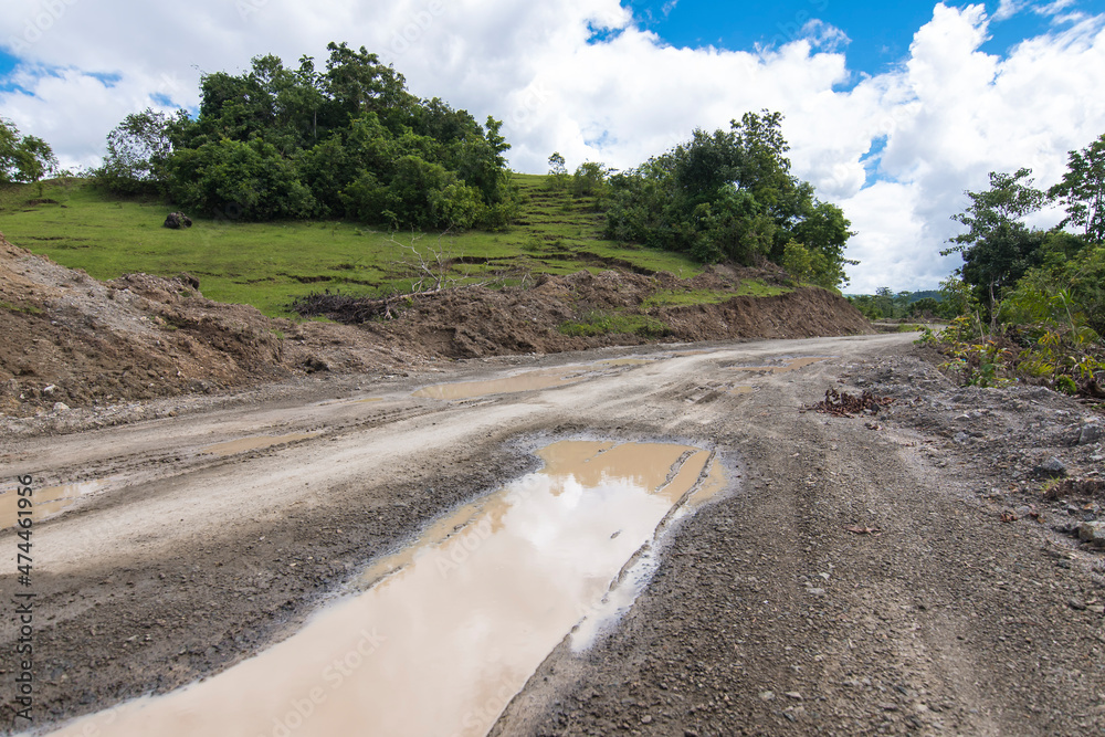 An unpaved dirt road in a remote location in Bohol, Philippines. Wet ...