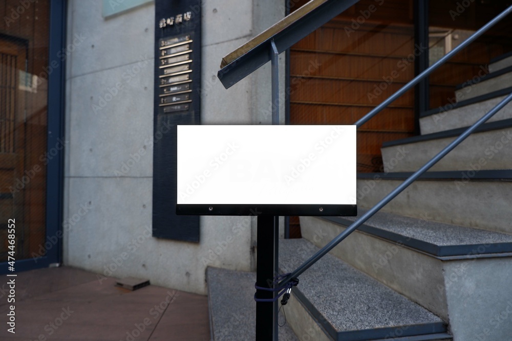 Blank sign board on a shop wall. Sign board mock up for cafe, store ...