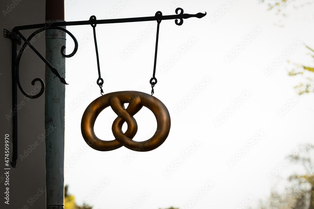 Pretzel signboard on white sky background. Bakery, cafe or pastry shop ...