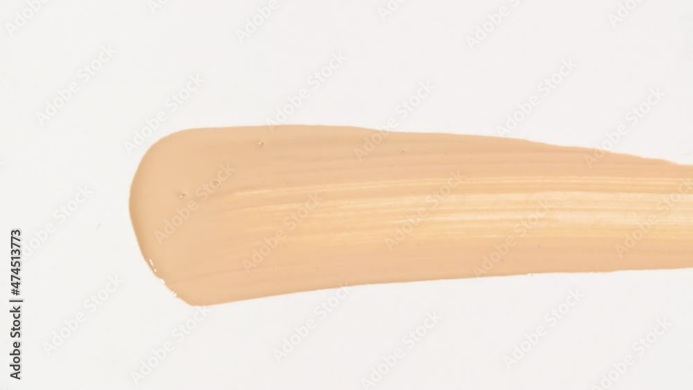 Macro shot and slow motion of a brush, applicator, smear, concealer ...
