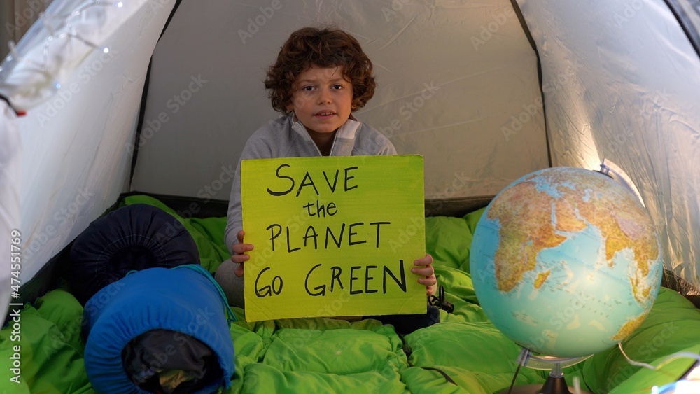 Italy, Milan , Activist boy Child 7 years old with sign Save the Planet ...