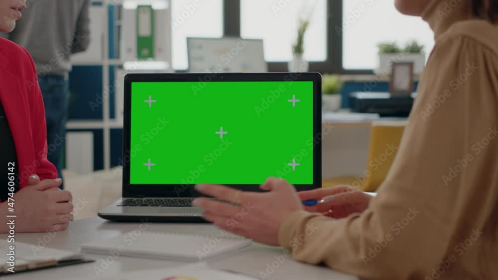 Close up of colleagues using green screen on laptop to work on business ...