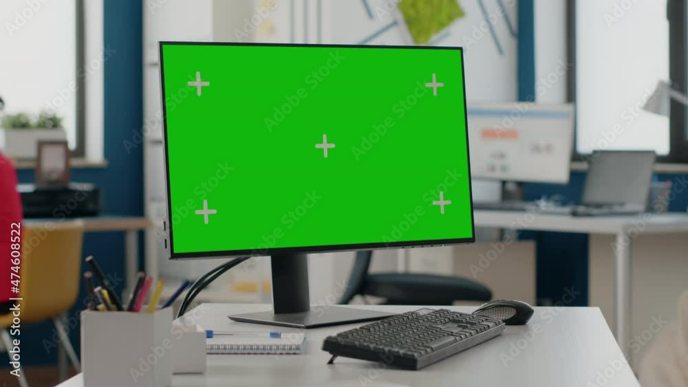 Close up of computer with isolated green screen at empty desk, mock up ...