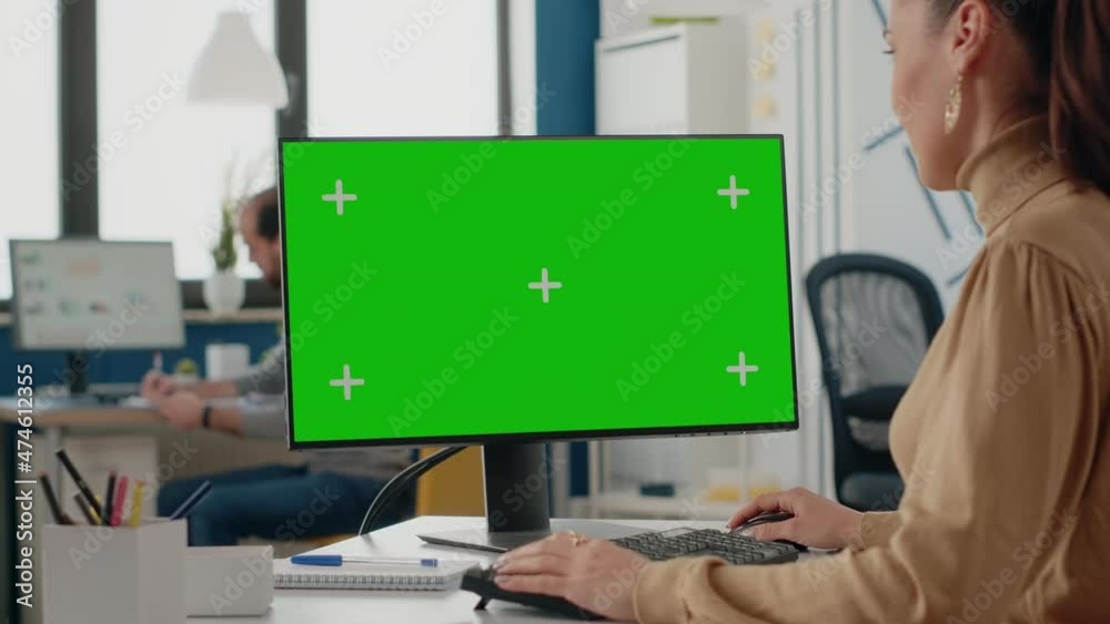 Close up of woman using computer with isolated green screen on display ...