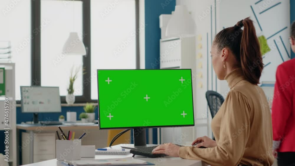 Business woman looking at computer with green screen. Person working ...