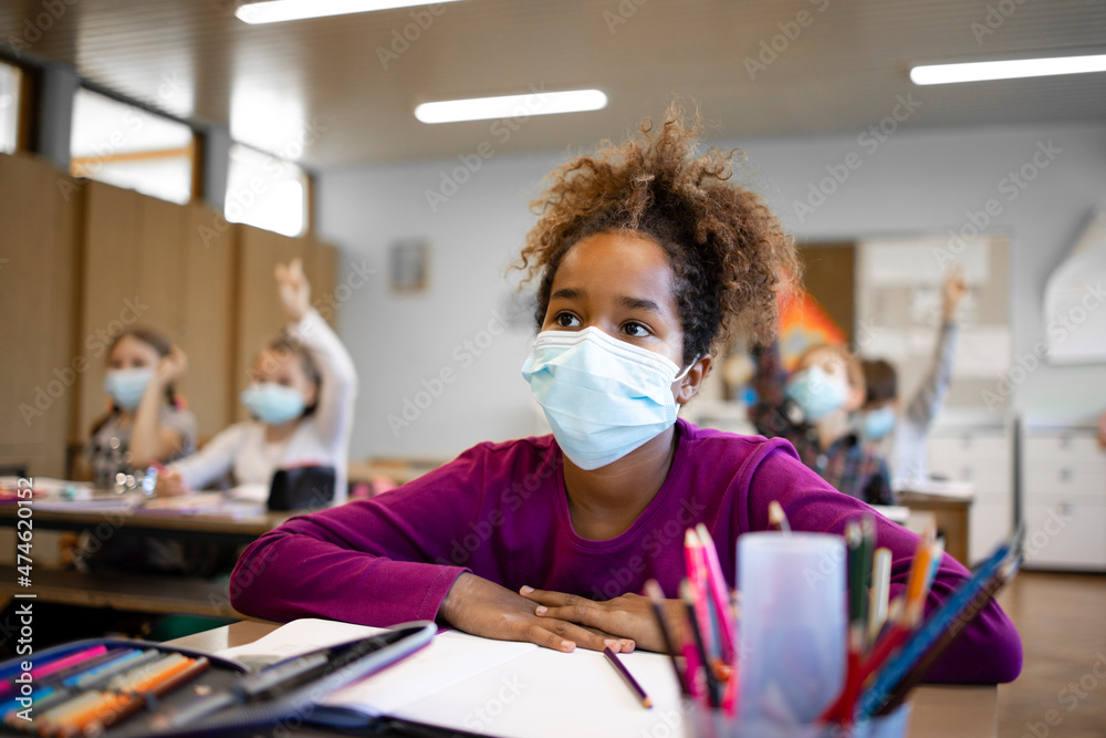 School children wearing face mask in classroom during corona virus ...