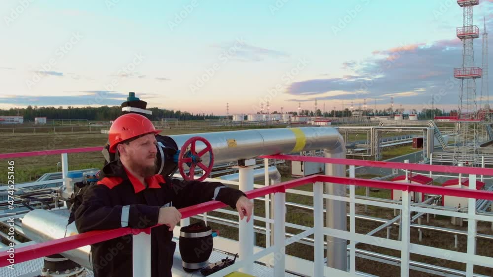 Oil and gas industry, engineer transmitting readings on a walkie-talkie ...
