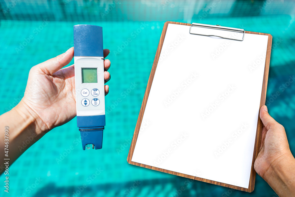 Digital water tester and blank white paper on wooden clipboard over ...