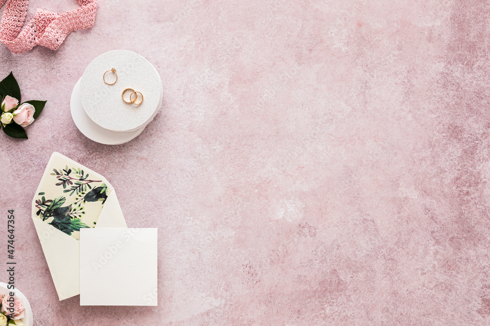 Studio shot of invitation card, ribbon, engagement ring and pair of ...