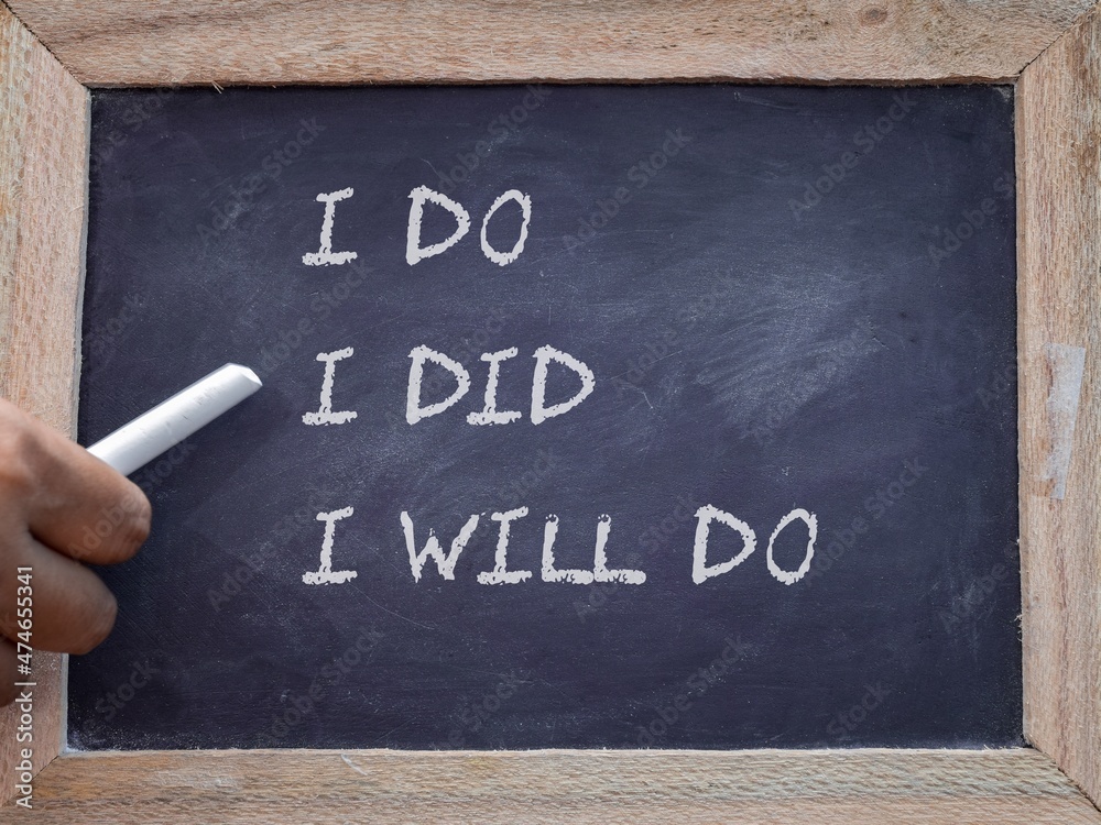 I do, I did, I will do text written on chalkboard. Past present future ...