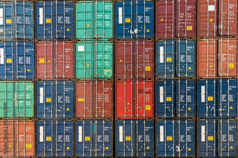 Stack of containers in a harbor. Shipping containers stacked on cargo ...