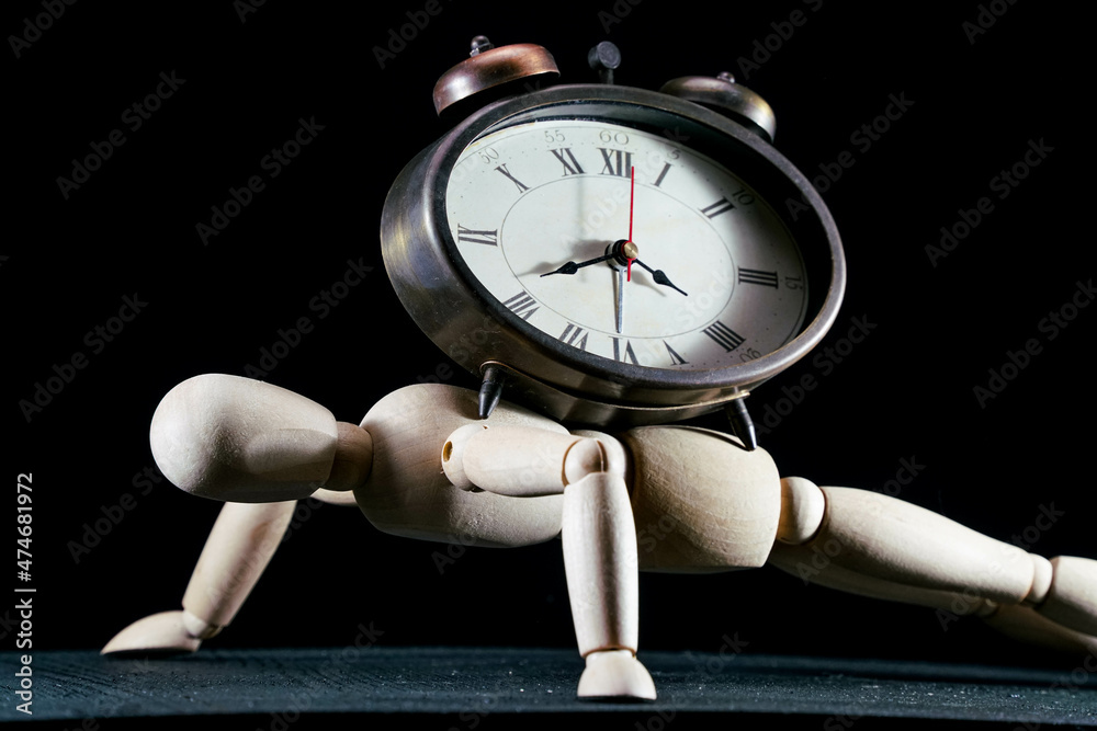Foto de wooden dummy and analogic clock, time concept, puppet made of ...