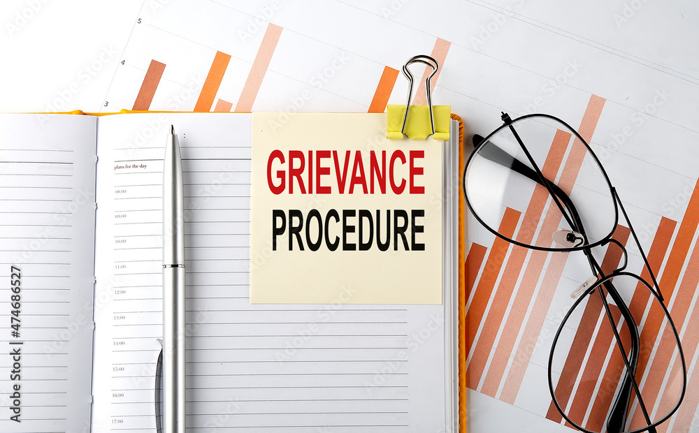 Text GRIEVANCE PROCEDURE on sticker on the notepad on diagram ...