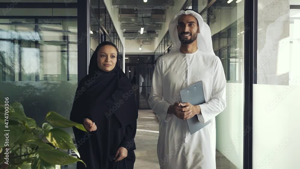 Man and woman with traditional clothes working in a business office of ...