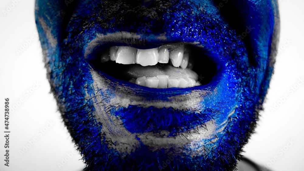 Face covered in blue paint with raised beard hair and cross mouth with ...