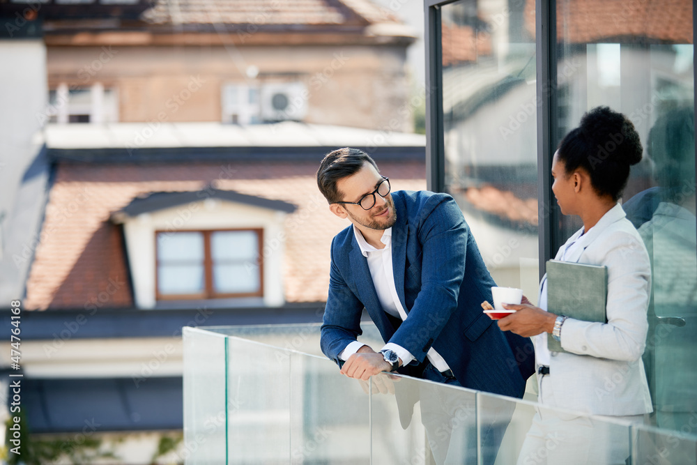 Business coworkers talk while drinking coffee on balcony at work. Stock ...