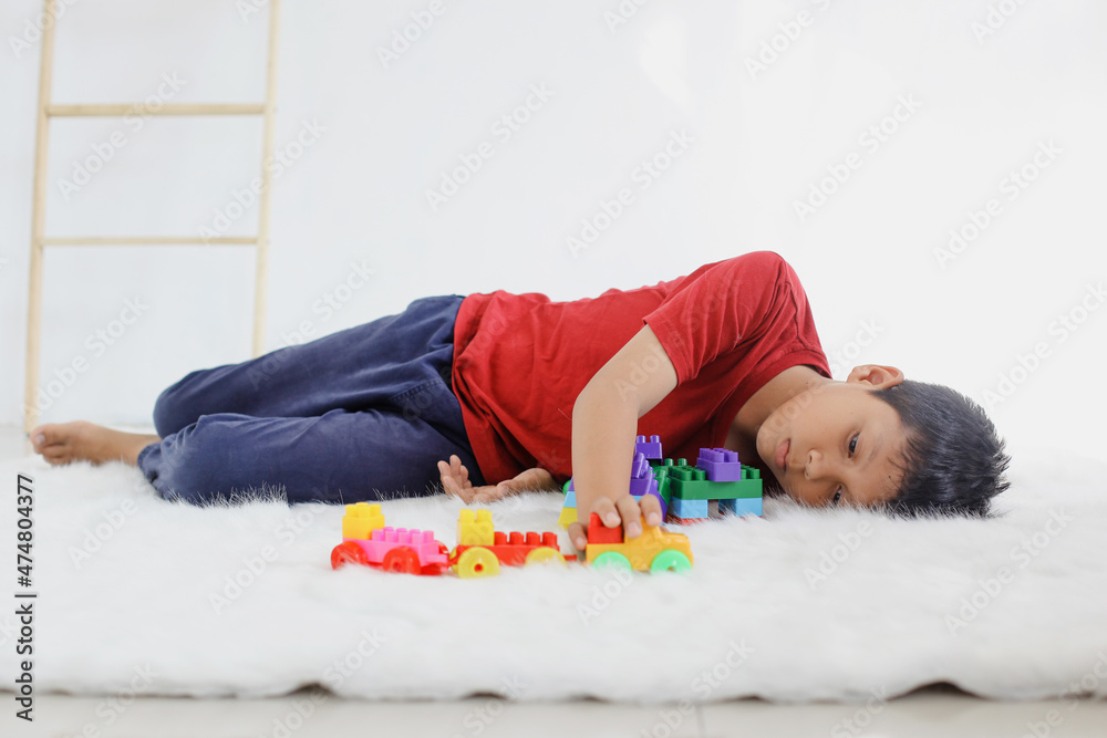 Sad and bored autistic child for being alone playing with toys ...
