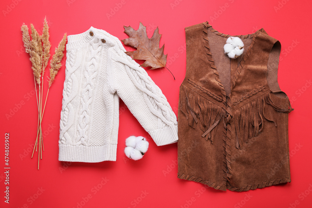 Baby clothes and natural forest decor on red background Stock Photo ...