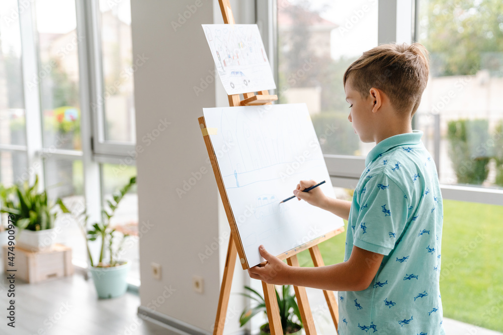 White blonde boy drawing during class in art school indoors Stock Photo ...