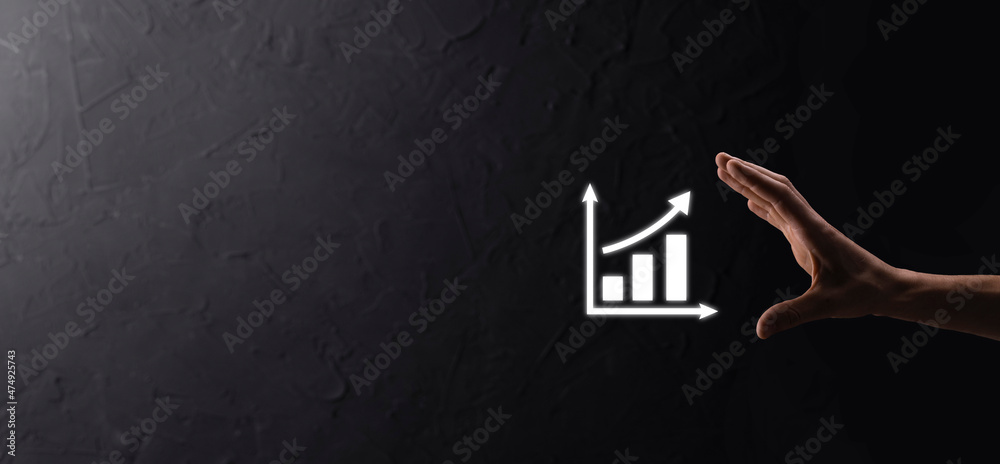 Businessman man holding a graph with positive profits growth. plan ...