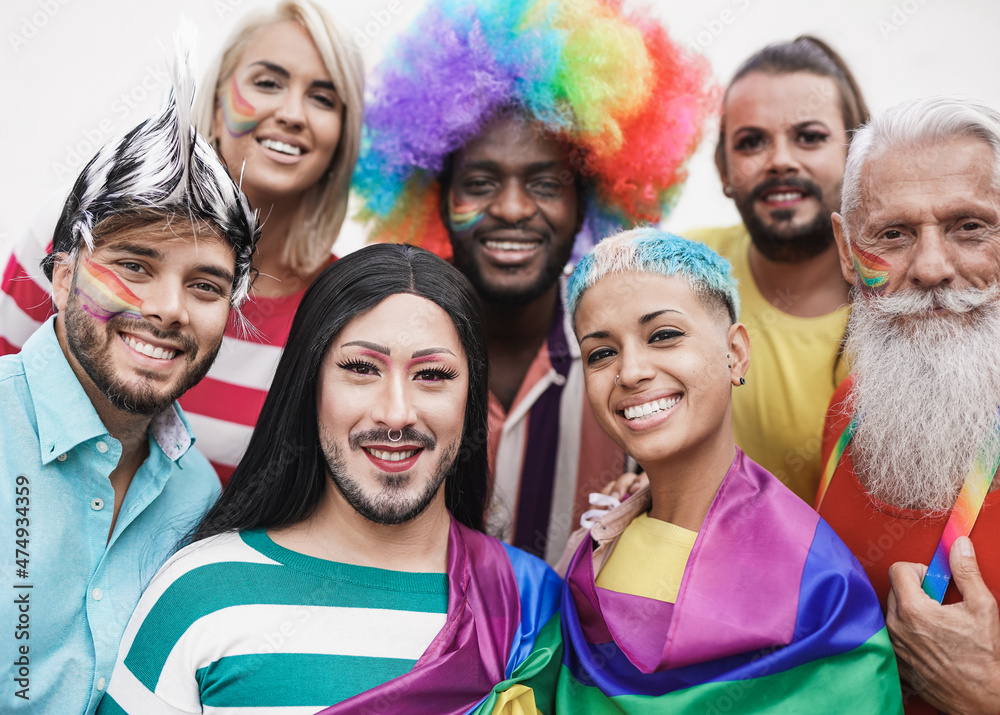 Multiracial people smiling on camera at LGBT pride parade - Diverse ...