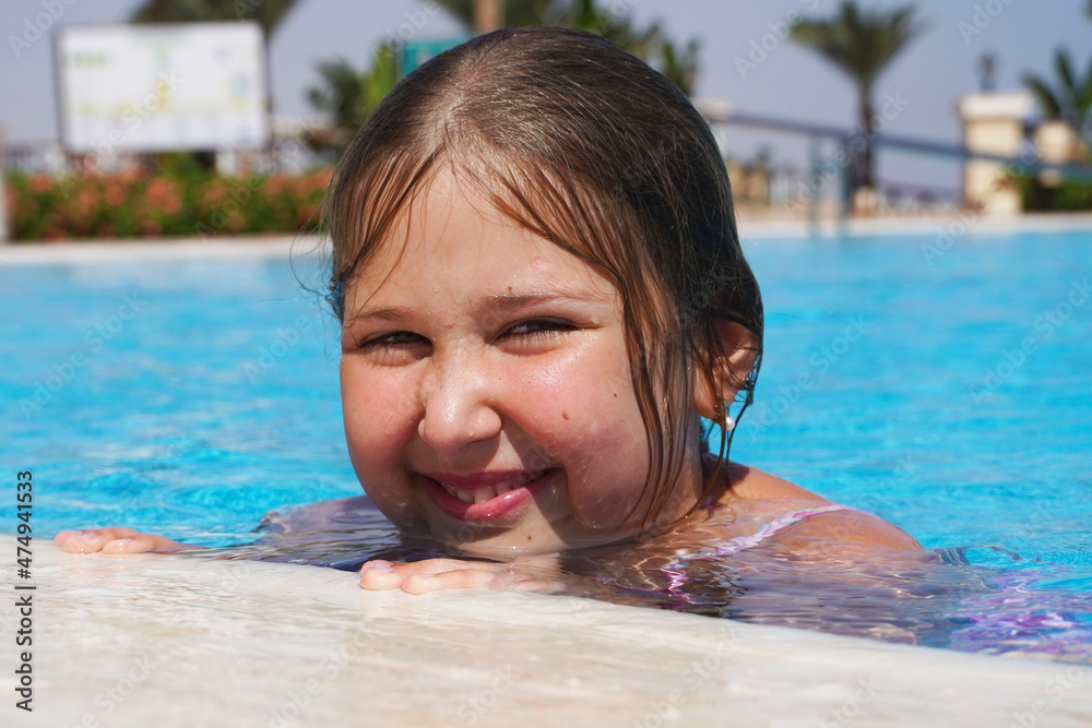 Foto de Funny smiling Little girl at swimming pool. Smiling Girl having ...