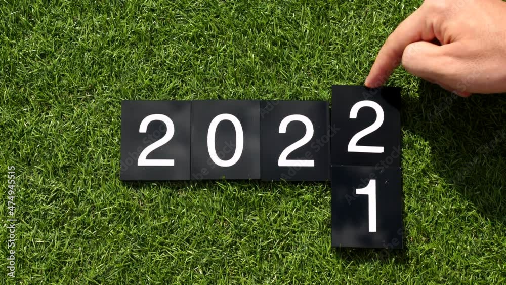 2021-2022 change. Happy New Year 2022. Man hand changes the plastic ...