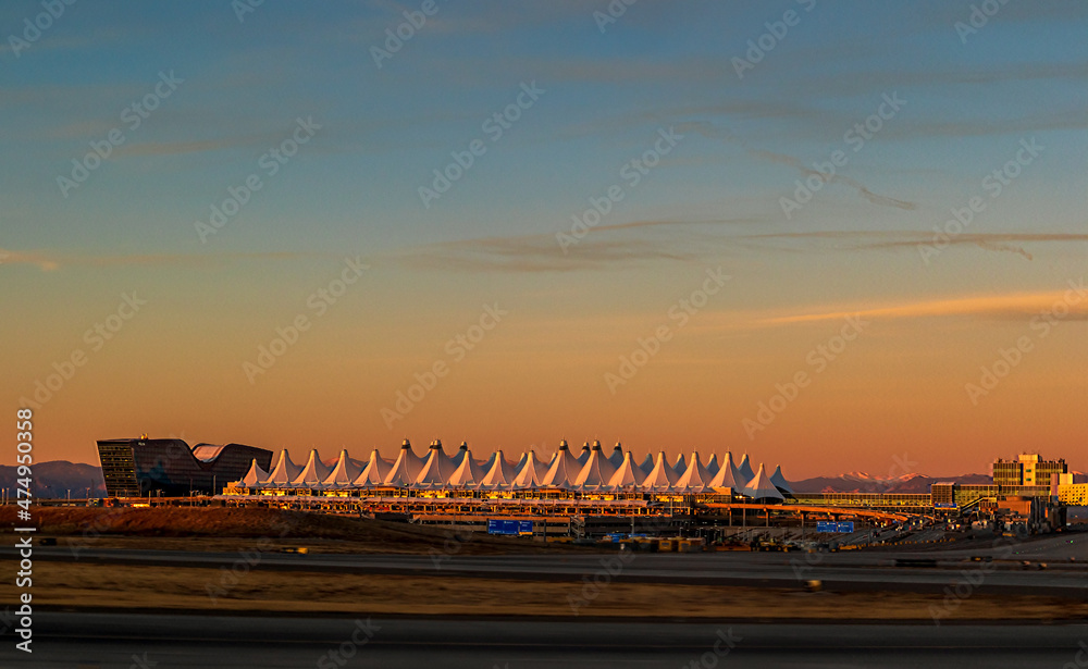 Poster Denver International Airport at dusk against the sunset sky ...