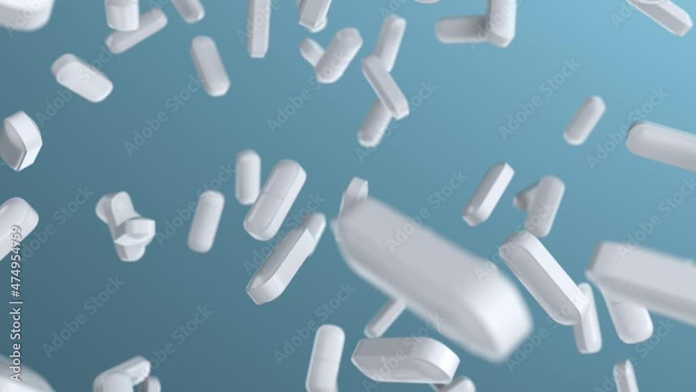 White pills and medicine tablets slowly falling on the laboratory ...