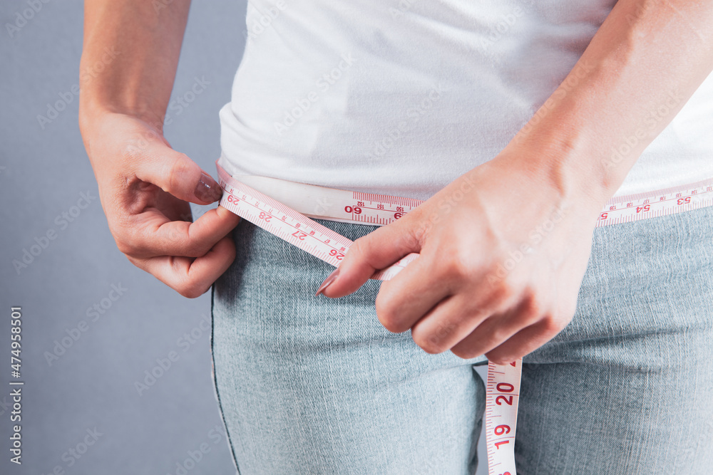 young girl measuring her waist with a measuring tape Stock Photo ...