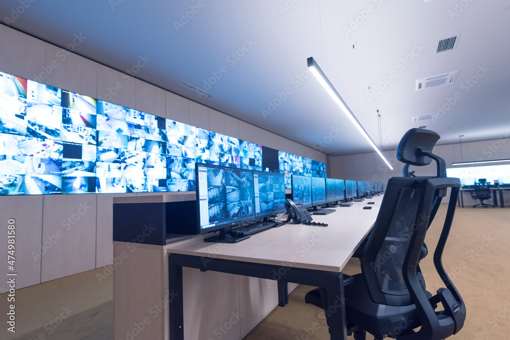 Security guard monitoring modern CCTV cameras in surveillance room ...