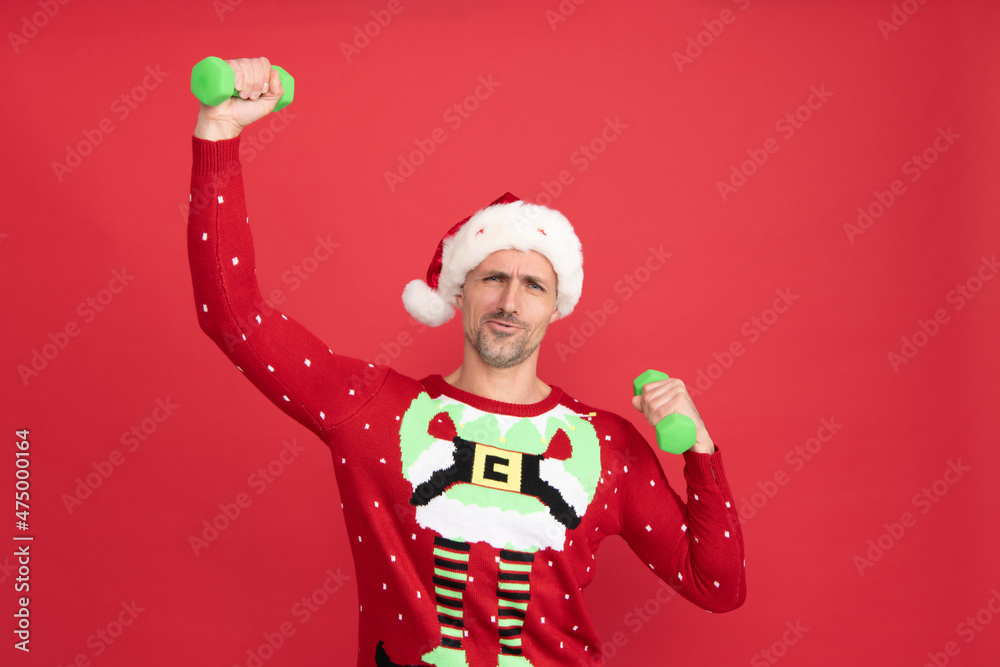 Never too late to be strong. Santa man do dumbbell workout. Christmas ...