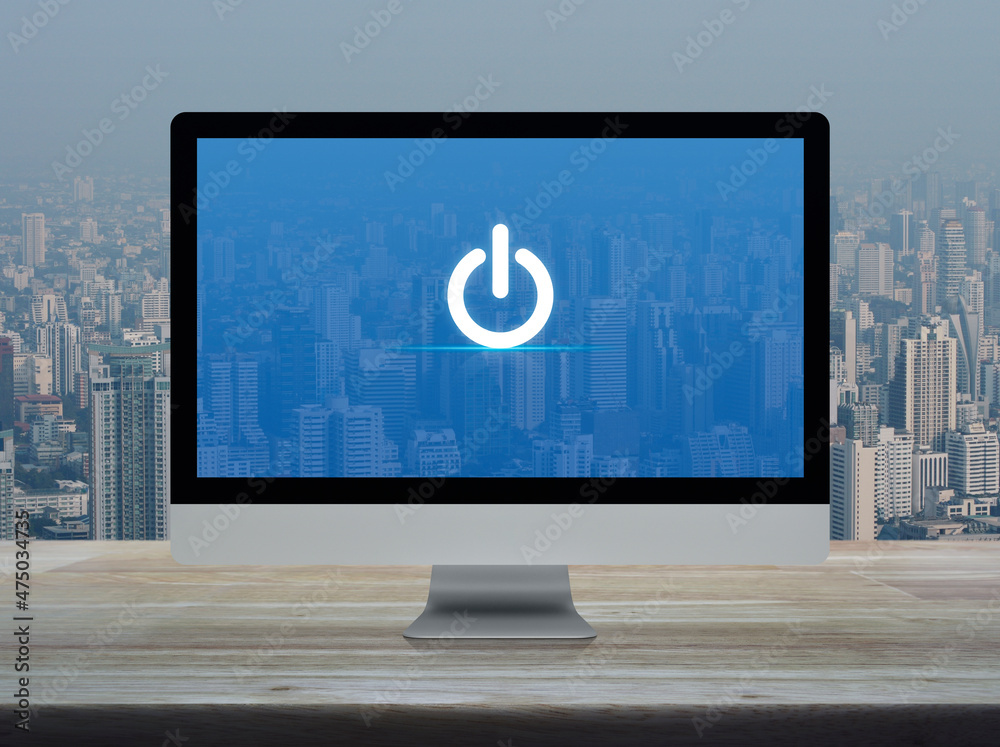 Power button icon on desktop modern computer monitor screen on wooden ...