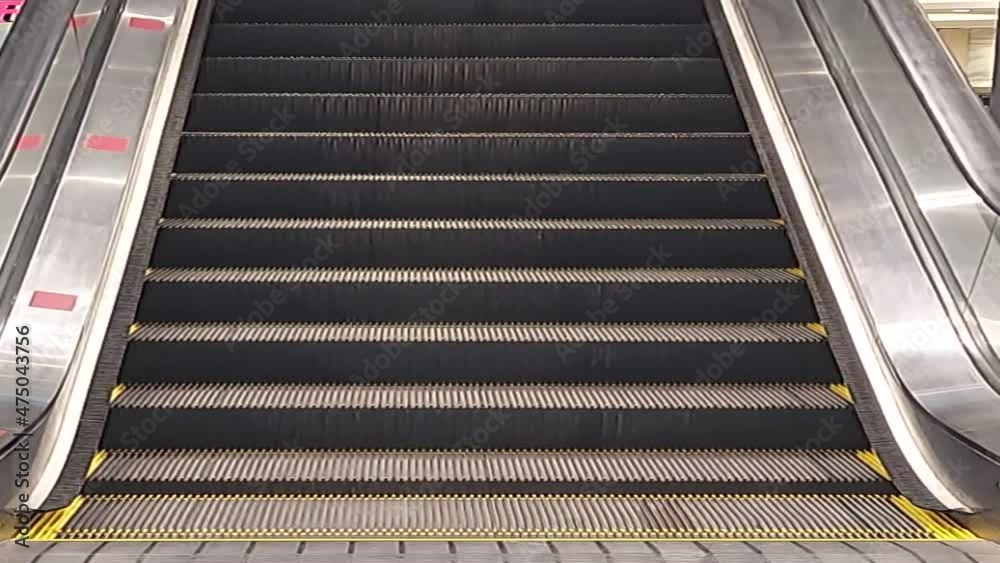A scrolling view circles the low angles of a modern escalator ...