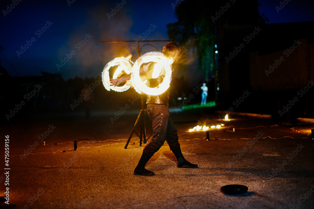 fire show artist spinning circles of fire with a stick Stock Photo ...