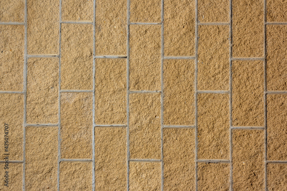 Beige wall tiles imitating brickwork. Modern finishing material. Gray ...