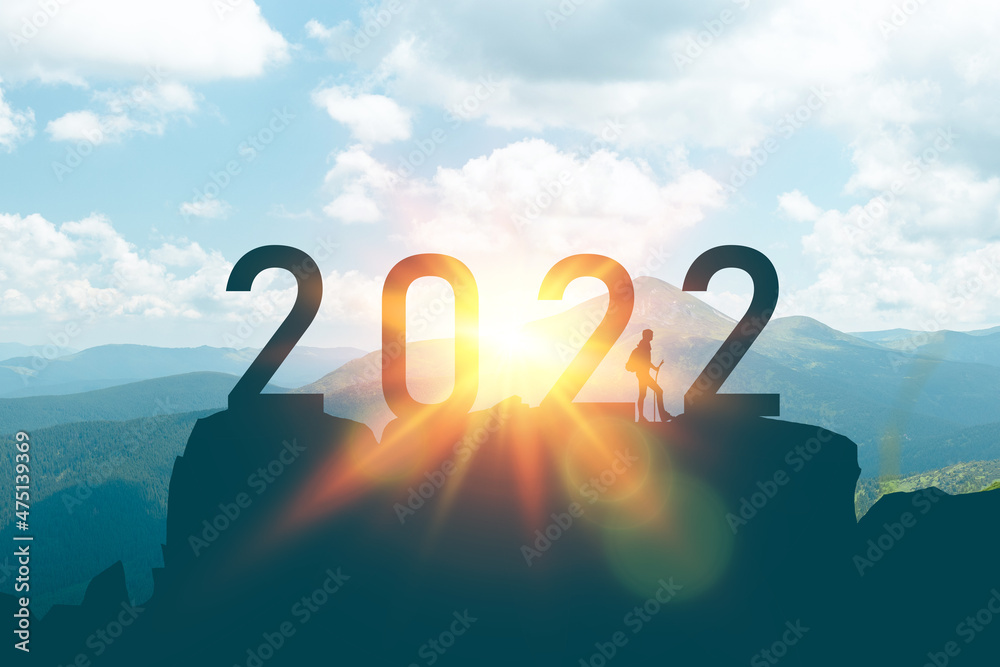 Loading year 2022. Successful lucky man to the top of the mountain from ...